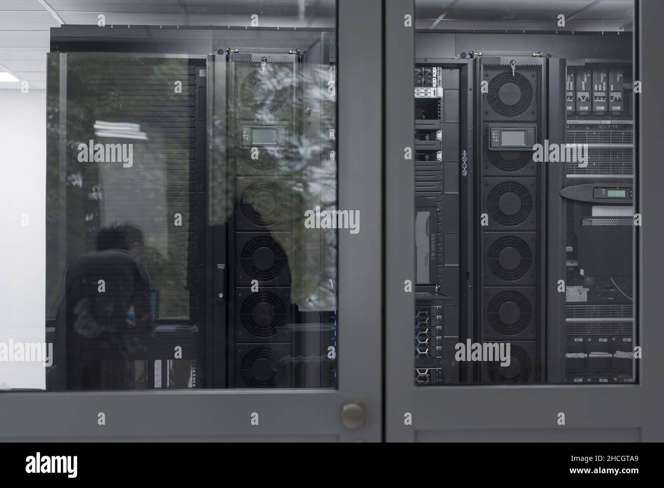Software Engineer Working on a Laptop Computer in a Modern Server room ...