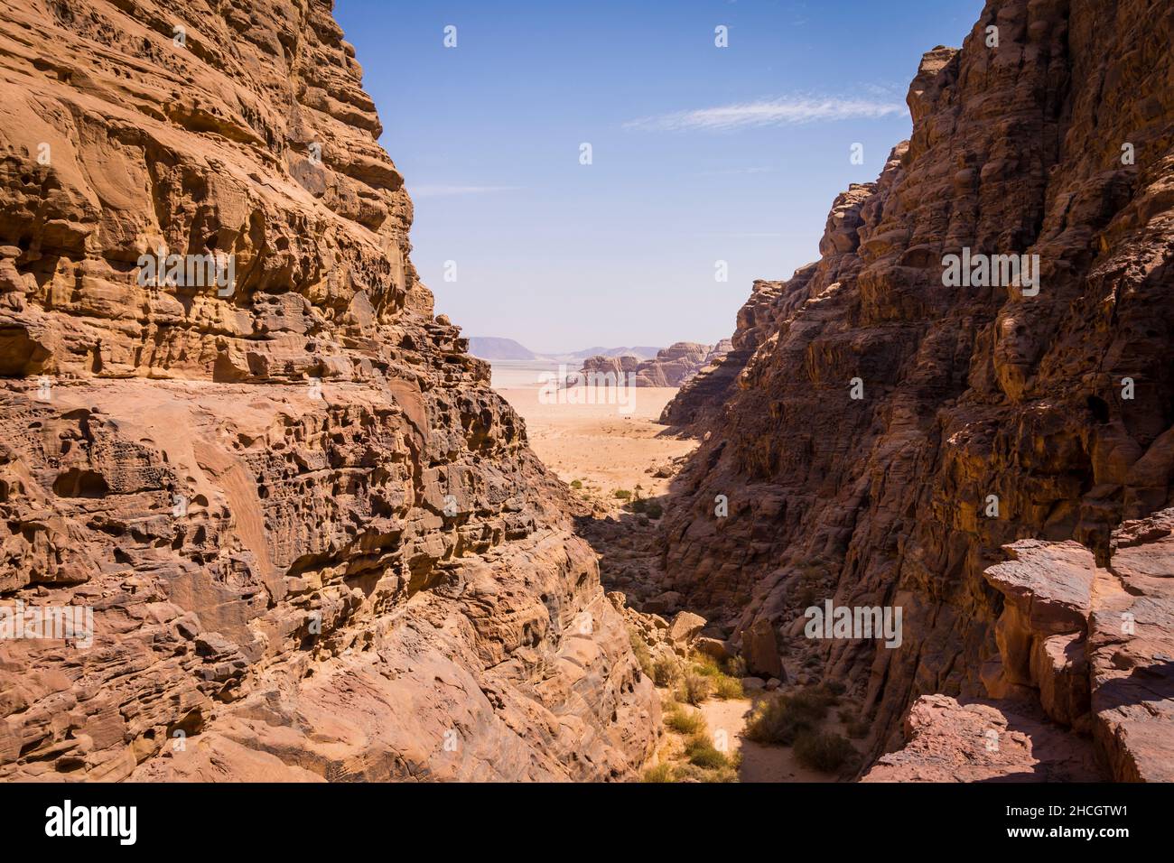 Gorge in the foreground in the middle of the desert with mountains in ...