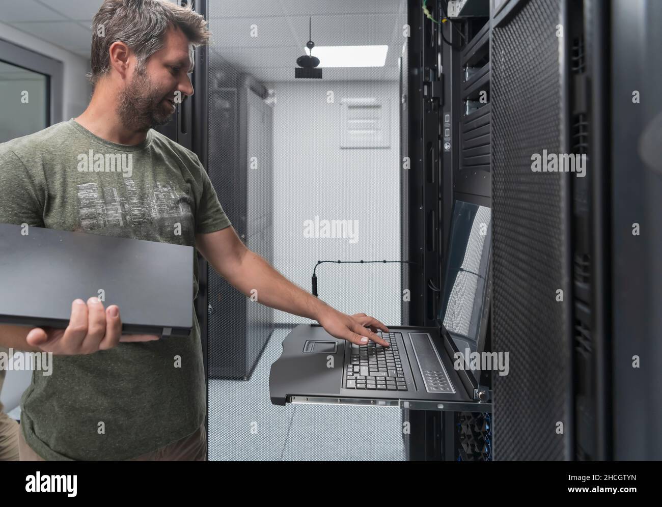 Close up on Data Center Engineer hands Using keyboard on a ...