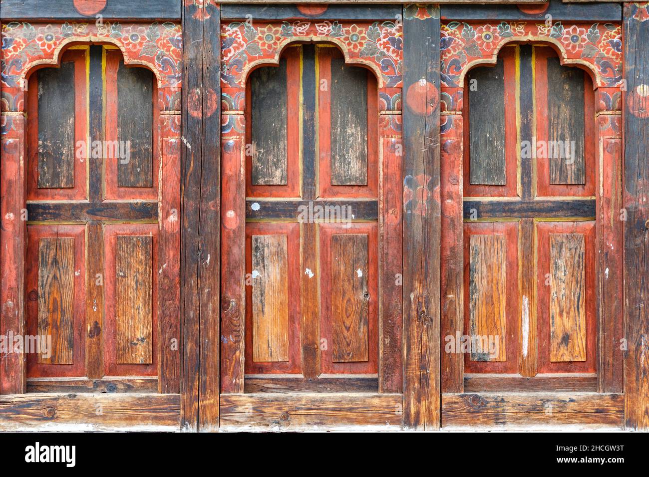 Painted brown shutters and windows in a Bhutanese buidling, Bhutan ...