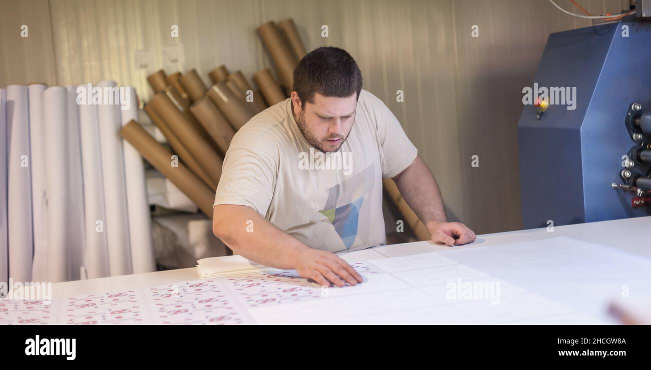 Logistic printing technician worker controls and arranges the printed ...