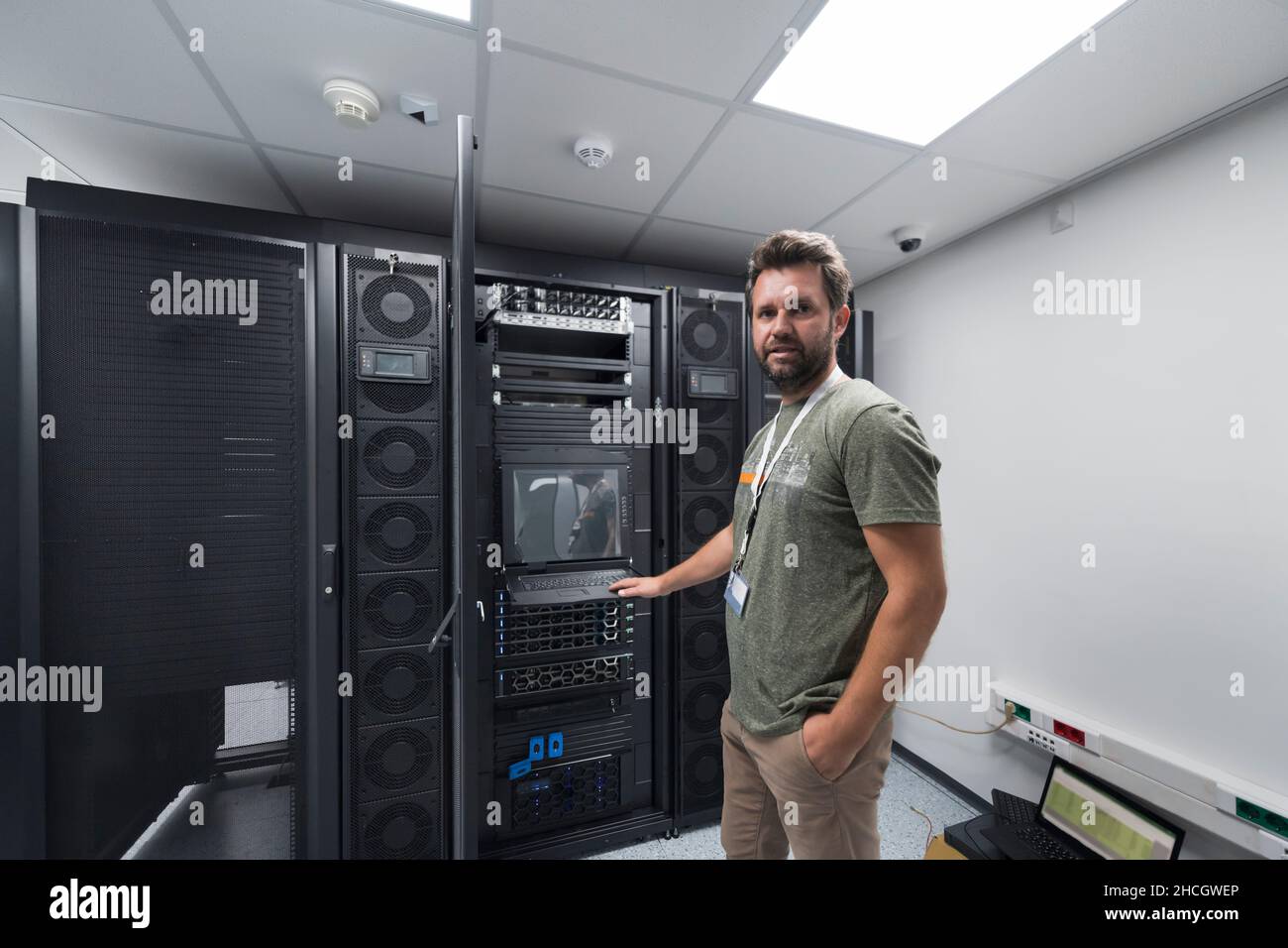 Data Center Engineer Usaing Keyboard on a Supercomputer Server Room ...
