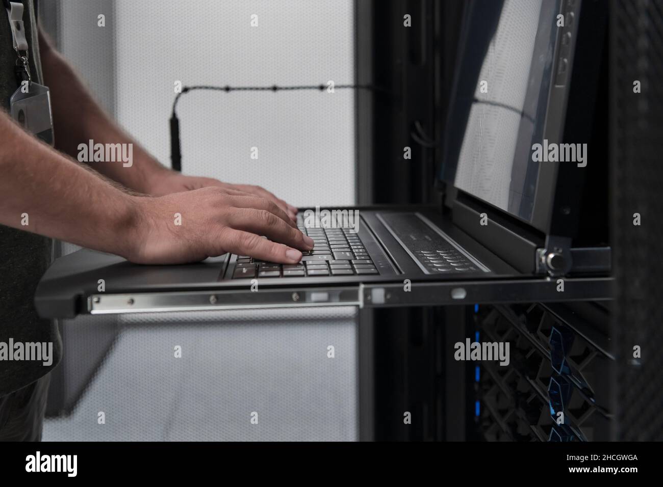 Close up on Data Center Engineer hands Using keyboard on a ...