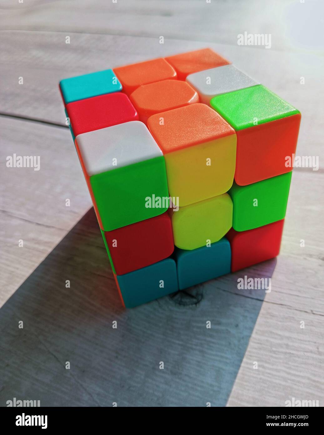 A unsorted puzzle-box in sunlight. The object is placed in a wooden ...