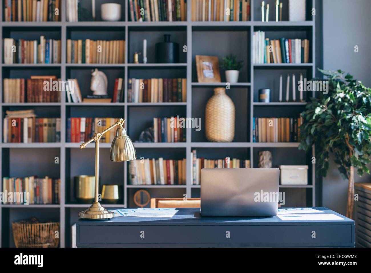 Table with laptop in home office interior Stock Photo - Alamy