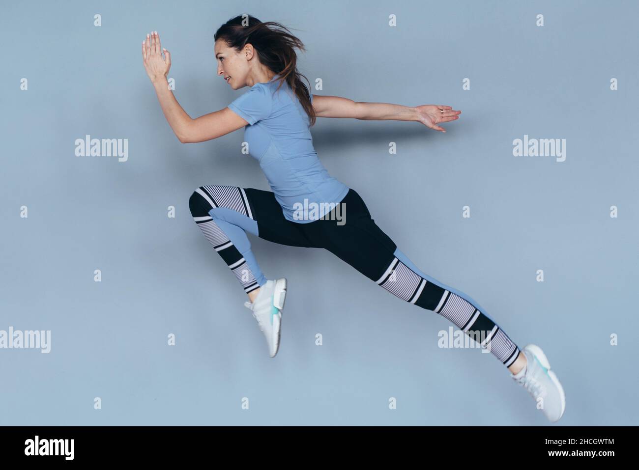 Fitness woman working out at home, jumping and running, doing intense ...