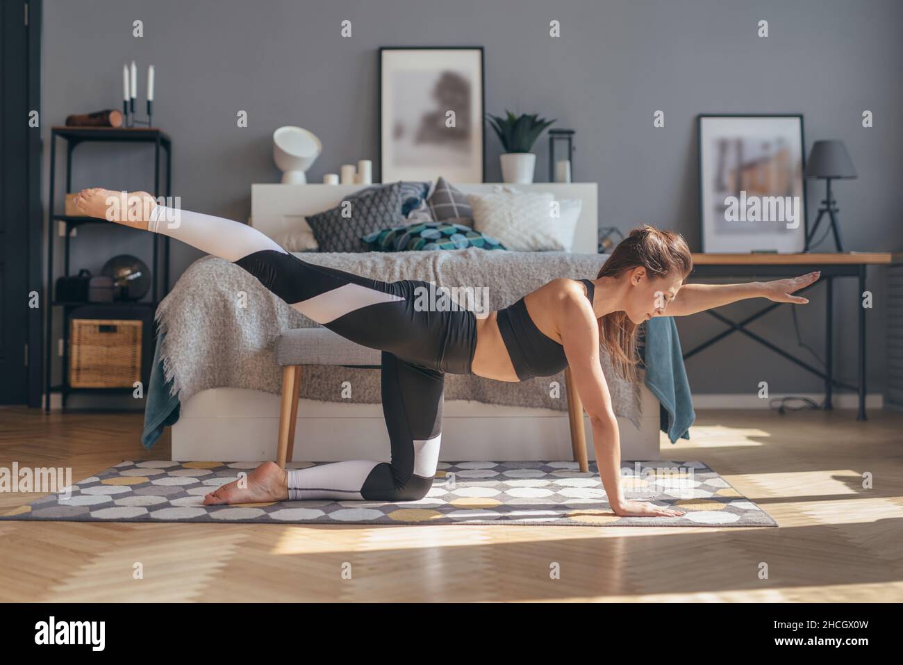 Fit woman excercising at home practising yoga Stock Photo - Alamy