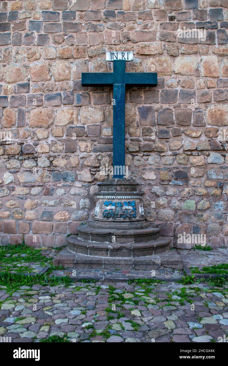 Colonial cross on stone wall background Stock Photo - Alamy
