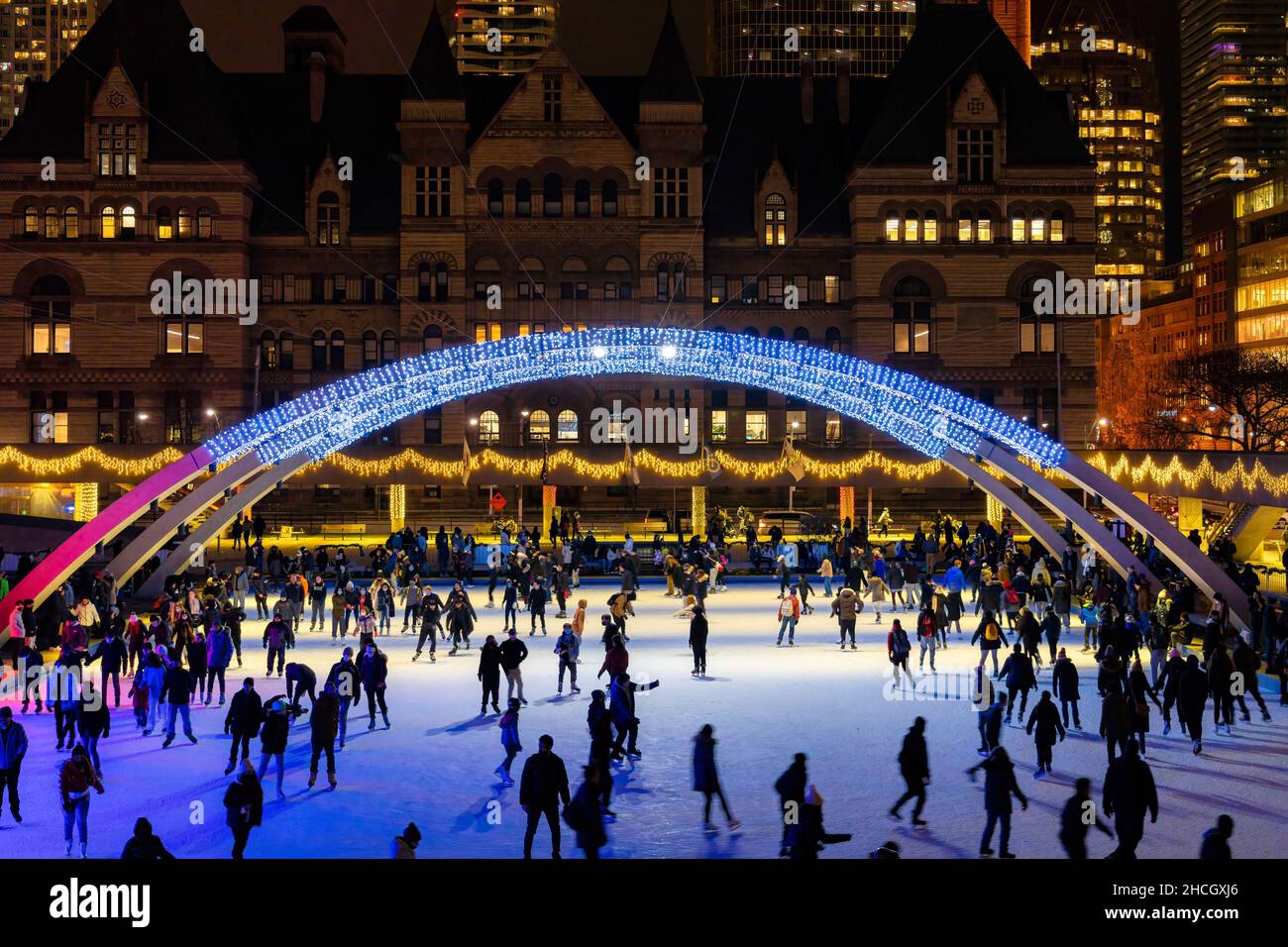 People skating under the 'Peace Arches' in Nathan Phillips Square which ...