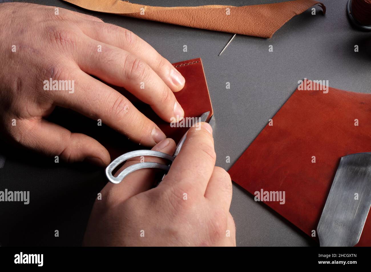 The process of making leather goods. The hands of the master work with ...