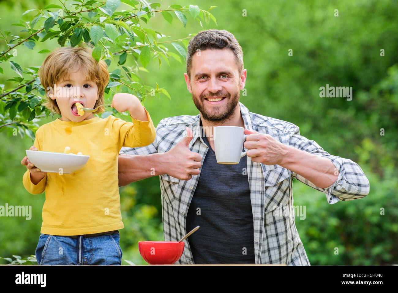 Father son eat food and have fun. Little boy and dad eating. Nutrition ...