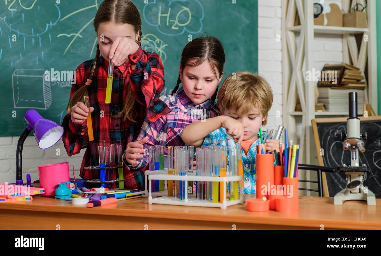 Pupil looking through microscope at the elementary school ...