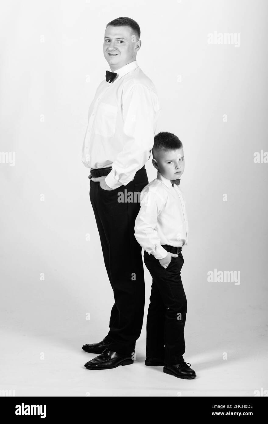 Gentleman upbringing. Little son following fathers example of noble man ...