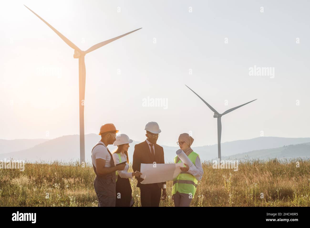 International team of business partners standing together among wind ...