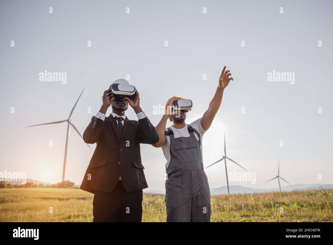African american businessman and indian engineer wearing VR headset ...