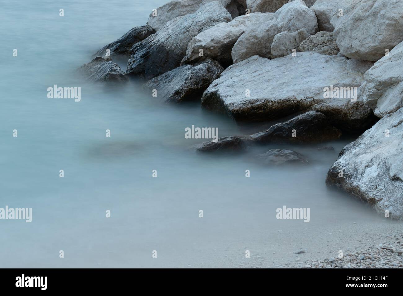 Detail from sea shore, landscape with wet rocks and pebble beach ...