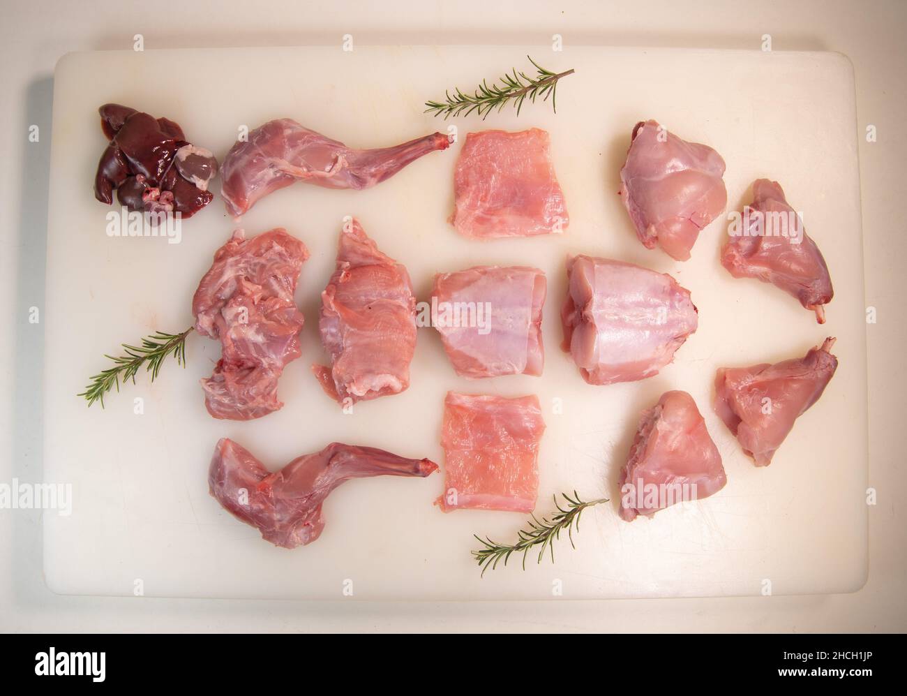 Raw rabbit cut out on a white cutting board. Top view, flat lay, close ...