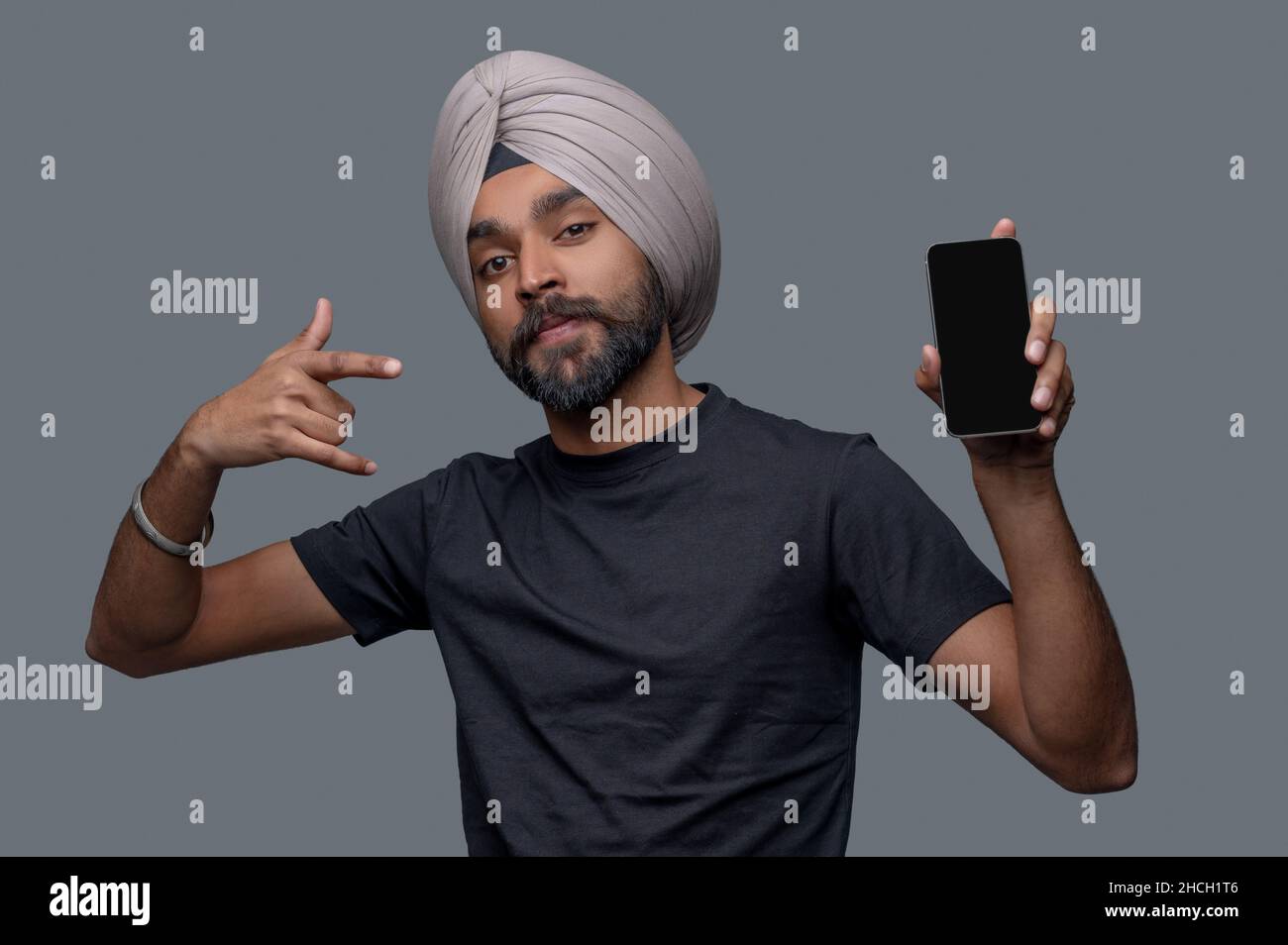 Male with the cellphone showing the hand sign Stock Photo - Alamy