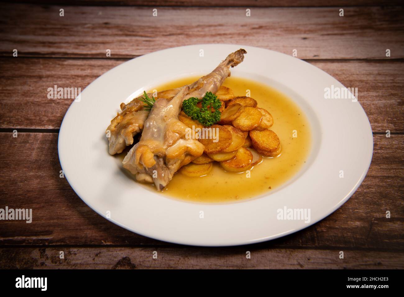 Rabbit casserole recipe with olives and herbs, sauteed potatoes Stock ...