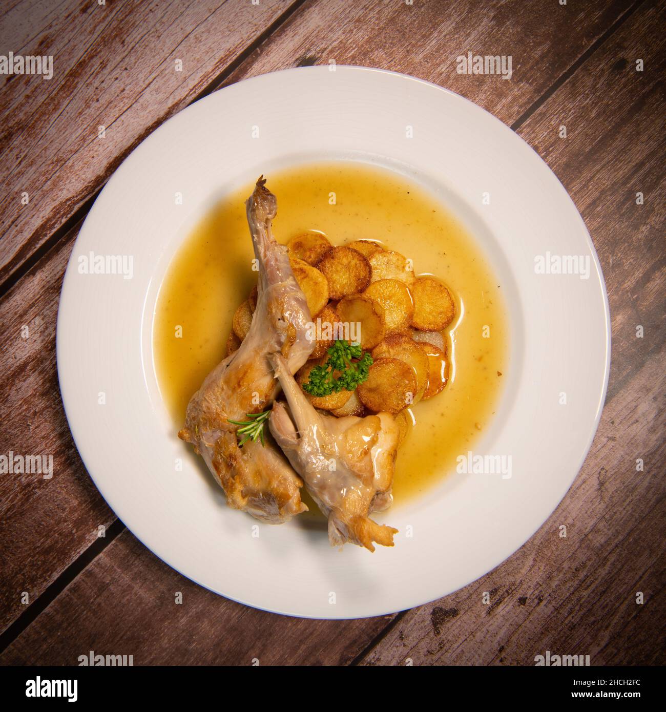 Rabbit casserole recipe with olives and herbs, sauteed potatoes Stock ...