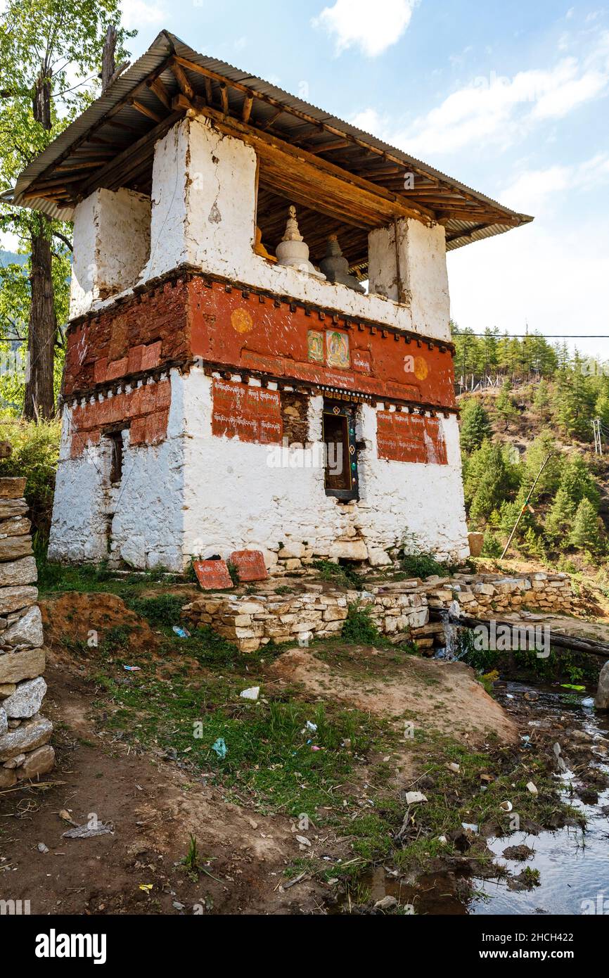 Tower with pagodas and chorten next to the ruins of the Drukgyel Dzong ...