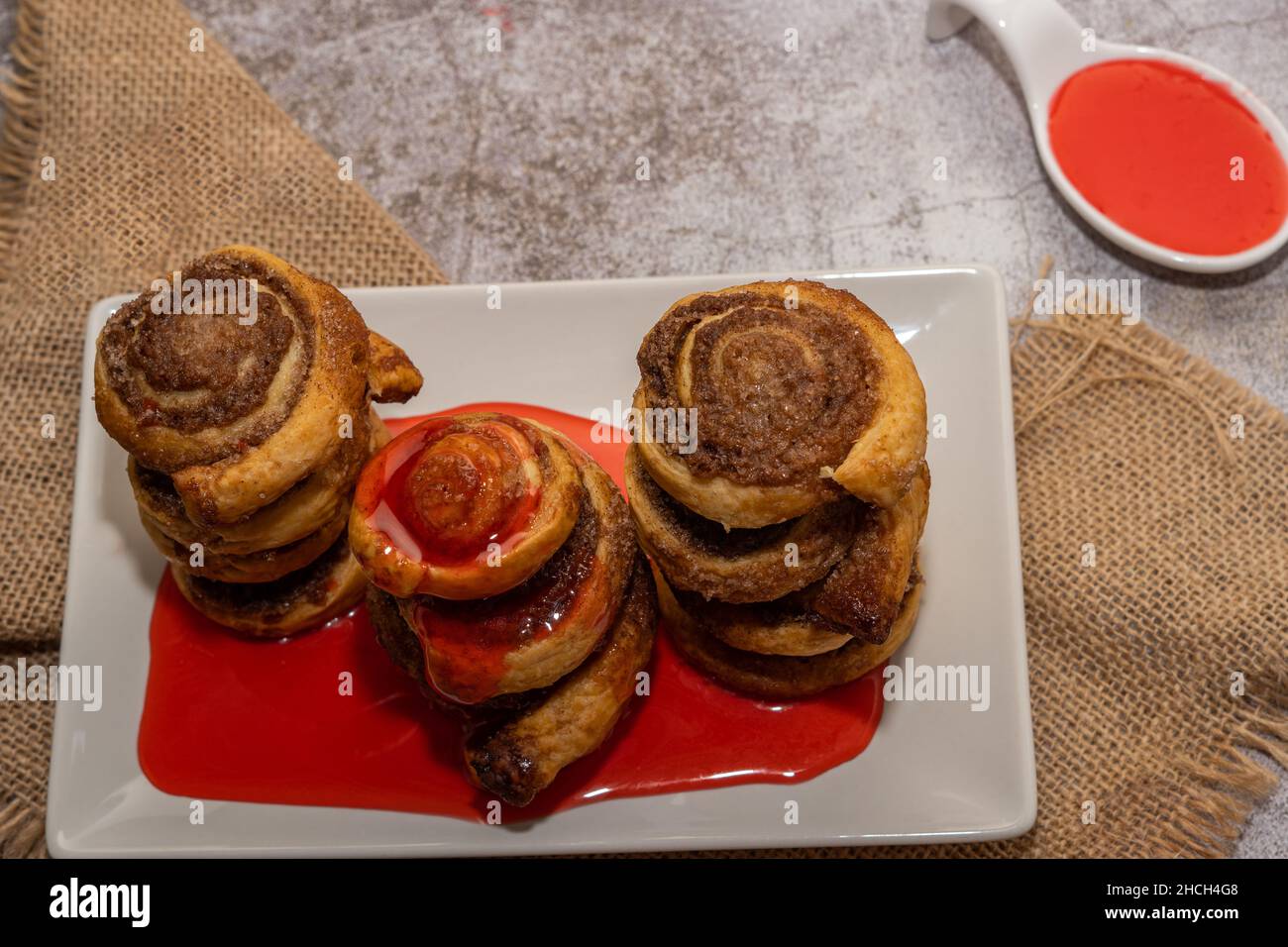 cinnamon and sugar rolls covered with strawberry syrup added with a ...