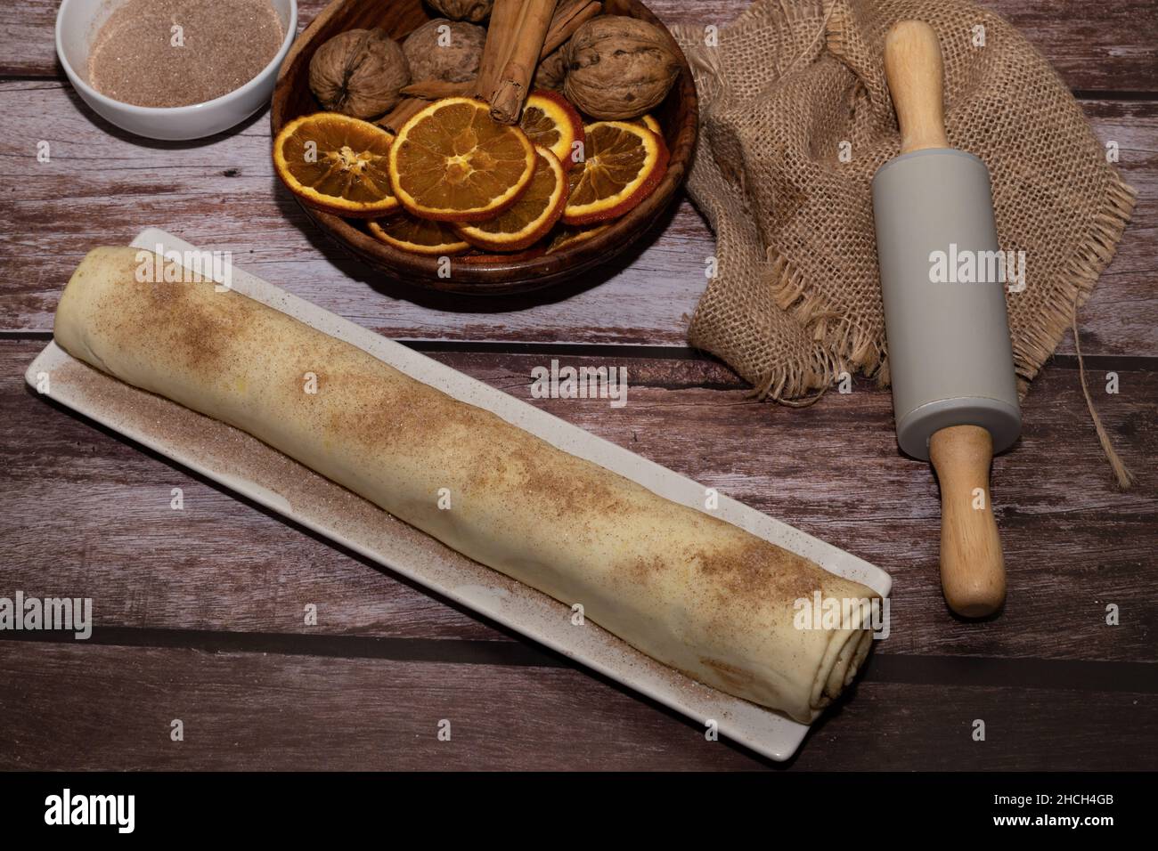 whole cinnamon and sugar roll ready to cut and bake on a white baking ...