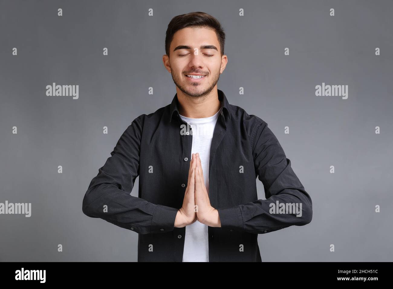 Man keeping hands namaste gesture and meditating Stock Photo - Alamy