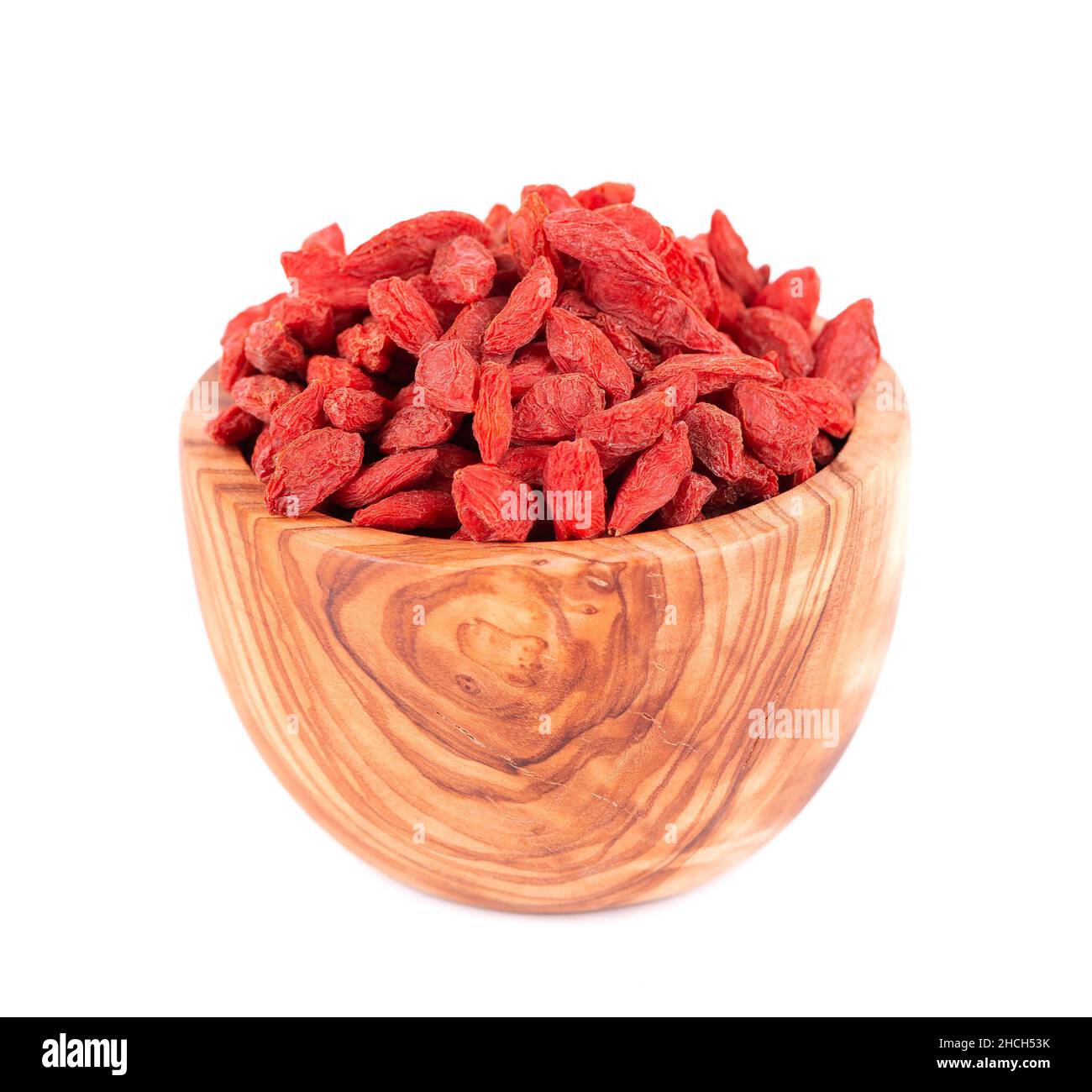 Chinese wolfberries in olive bowl, isolated on white background. Heap ...