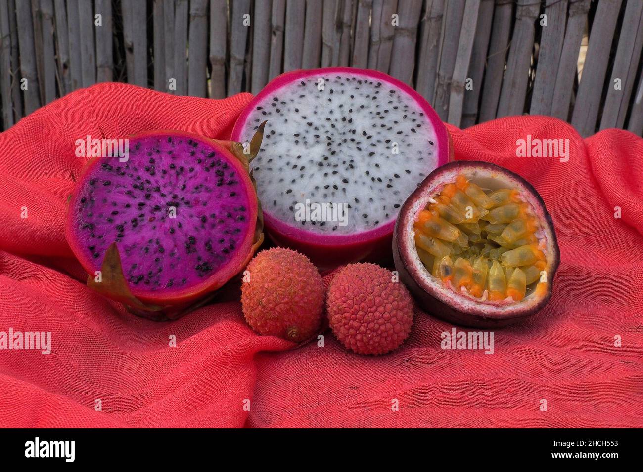 Halved white and red dragon fruit (pitahaya) with passion fruit and ...