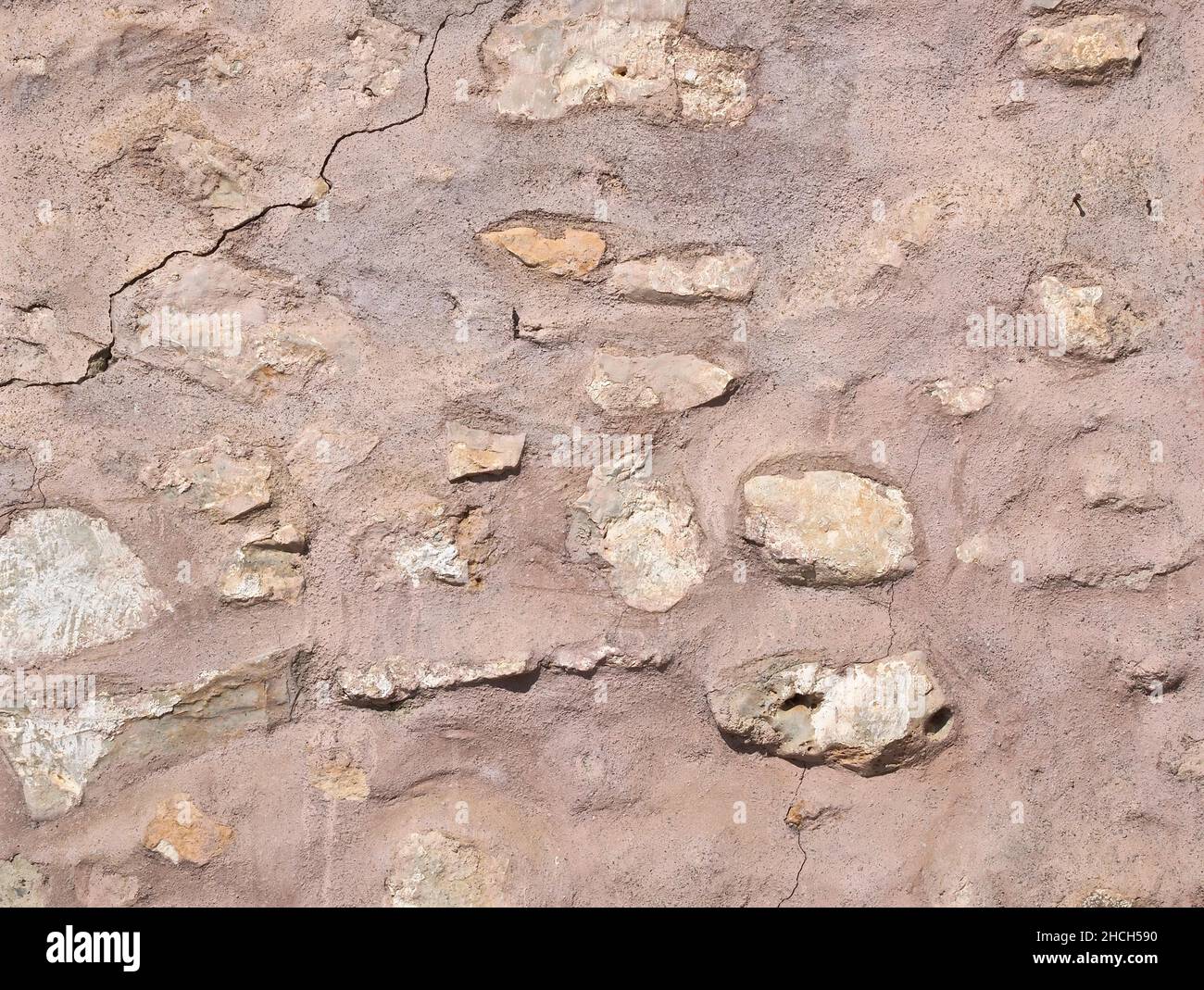 Natural stone wall with clay plaster Stock Photo - Alamy