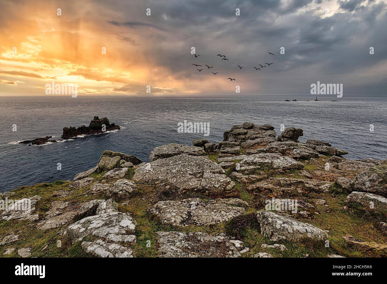 Coast with rock Armed Knight and lighthouse Wolf Rock on the horizon ...