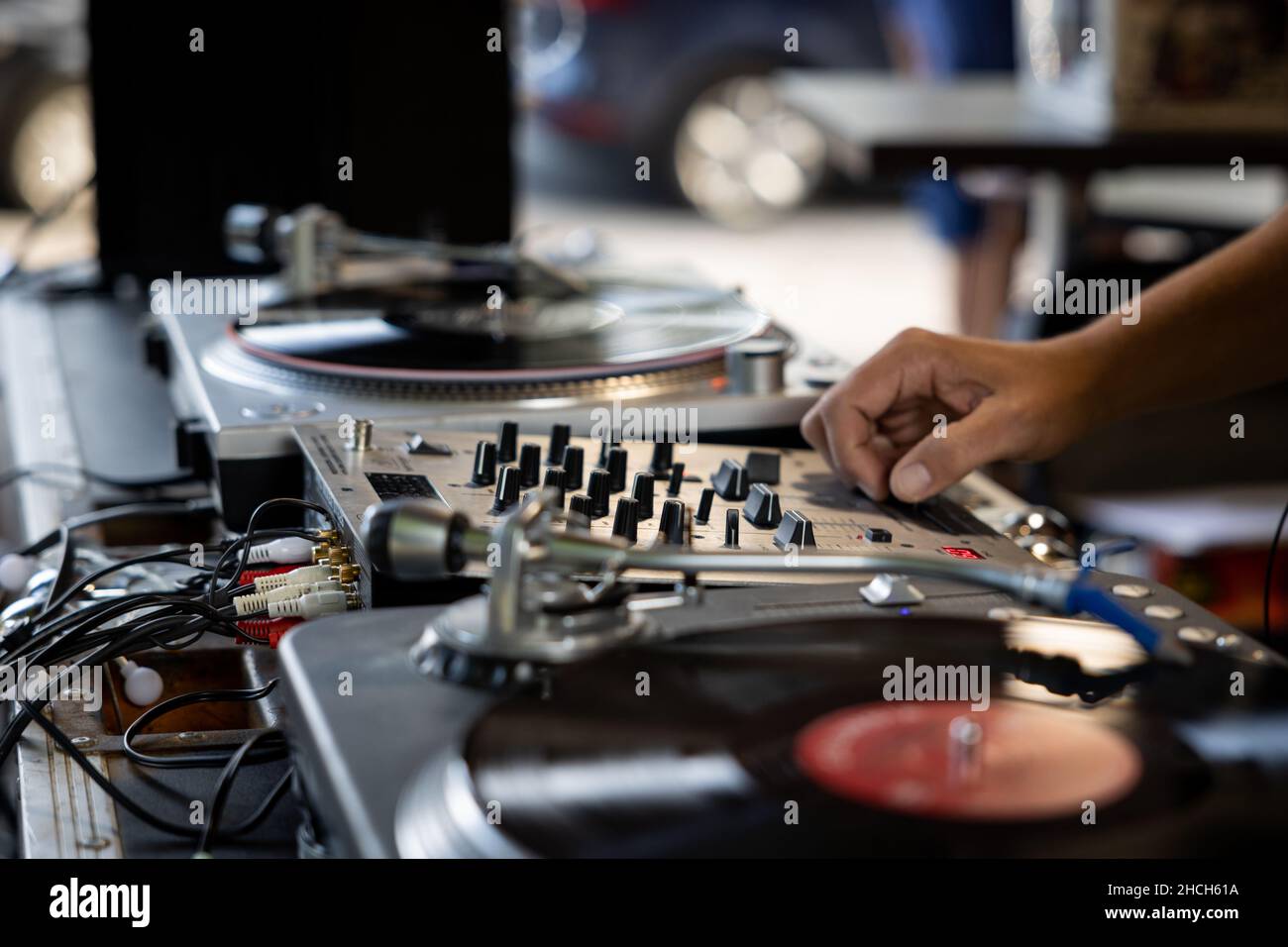 DJ on a mixer with turntables Stock Photo - Alamy