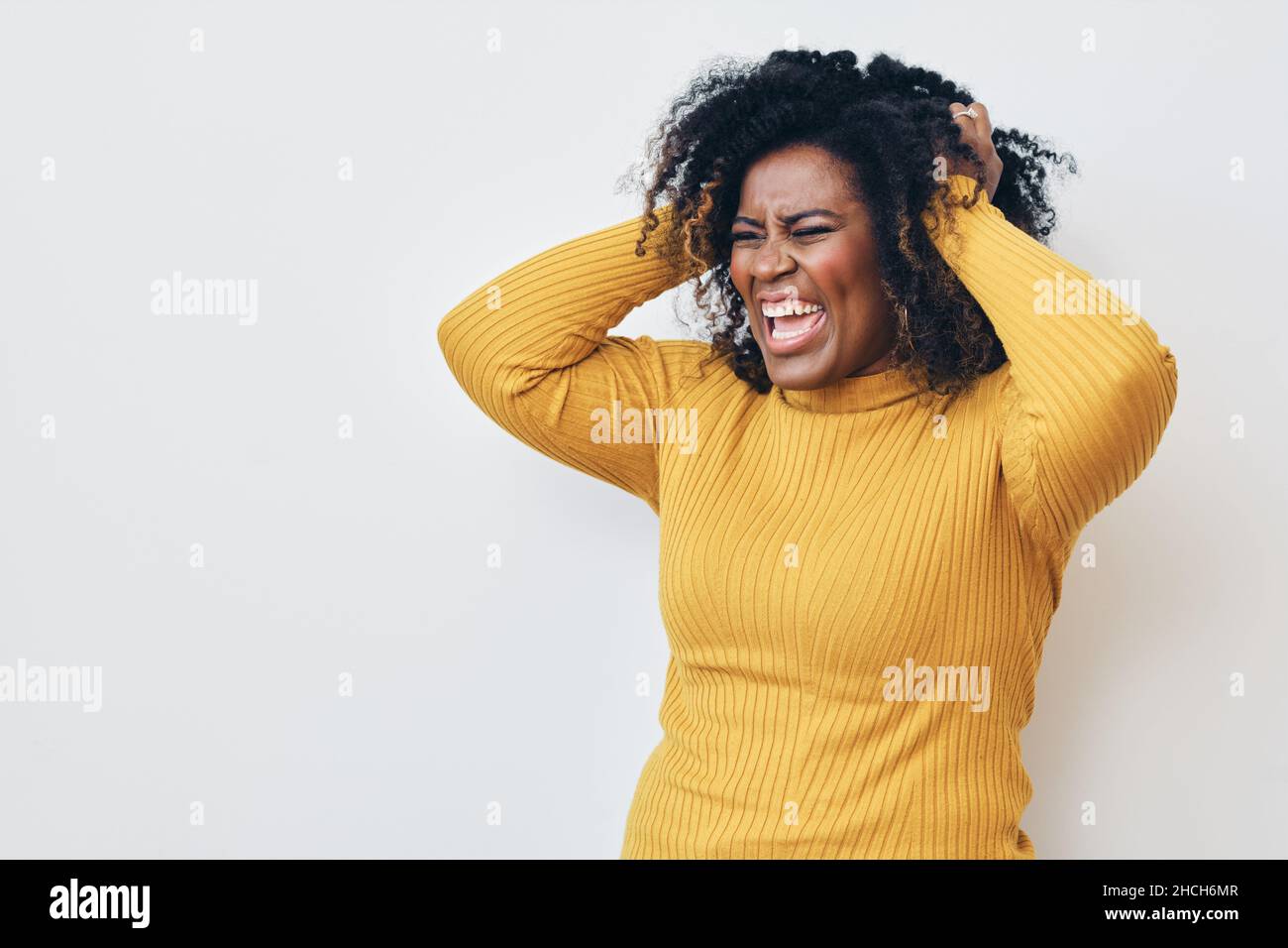 Screaming in pain woman struggling with headache looking away against ...