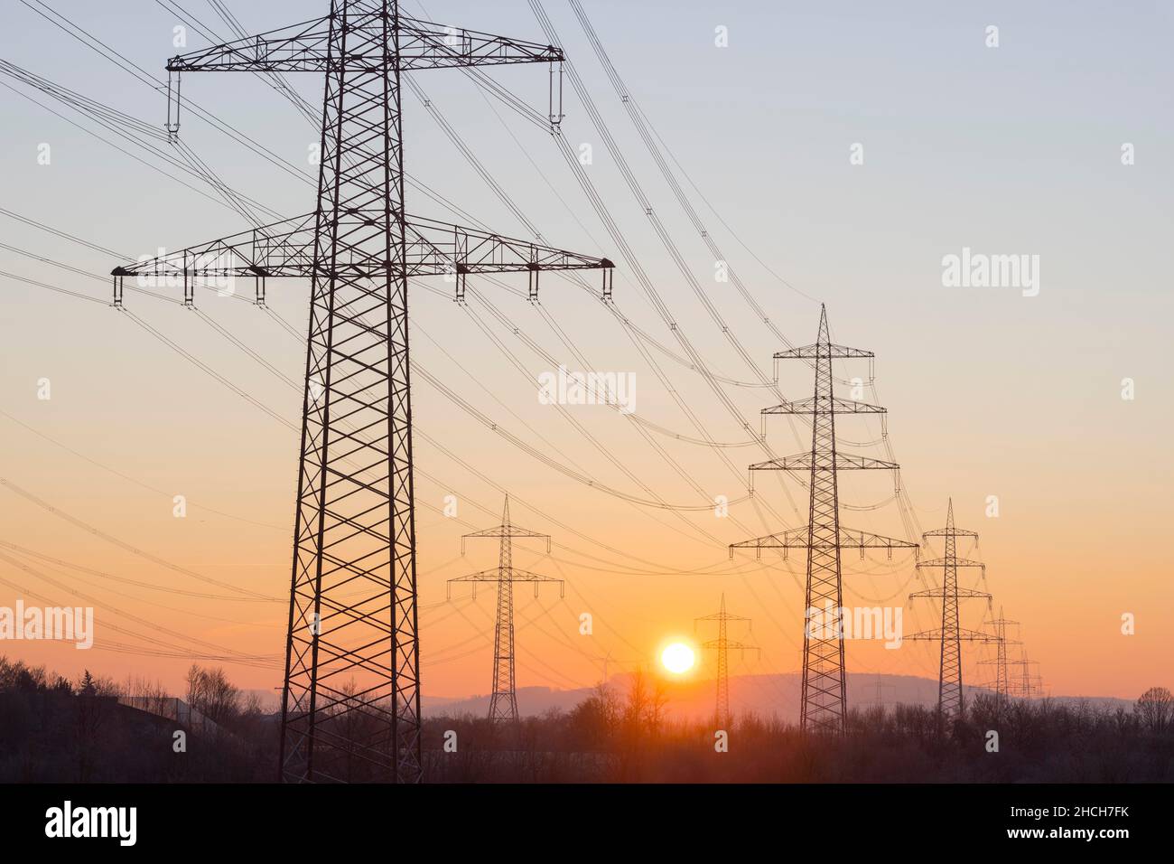 High-voltage pylons, overhead power lines, sunrise, Baden-Wuerttemberg ...