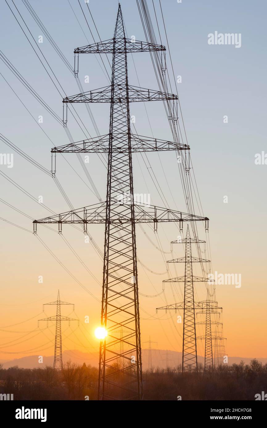 High-voltage pylons, overhead power lines, sunrise, Baden-Wuerttemberg ...