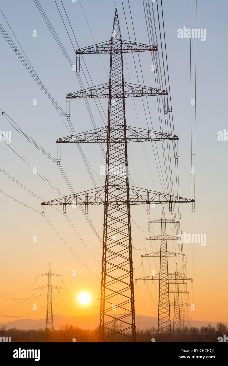 High-voltage pylons, overhead power lines, sunrise, Baden-Wuerttemberg ...