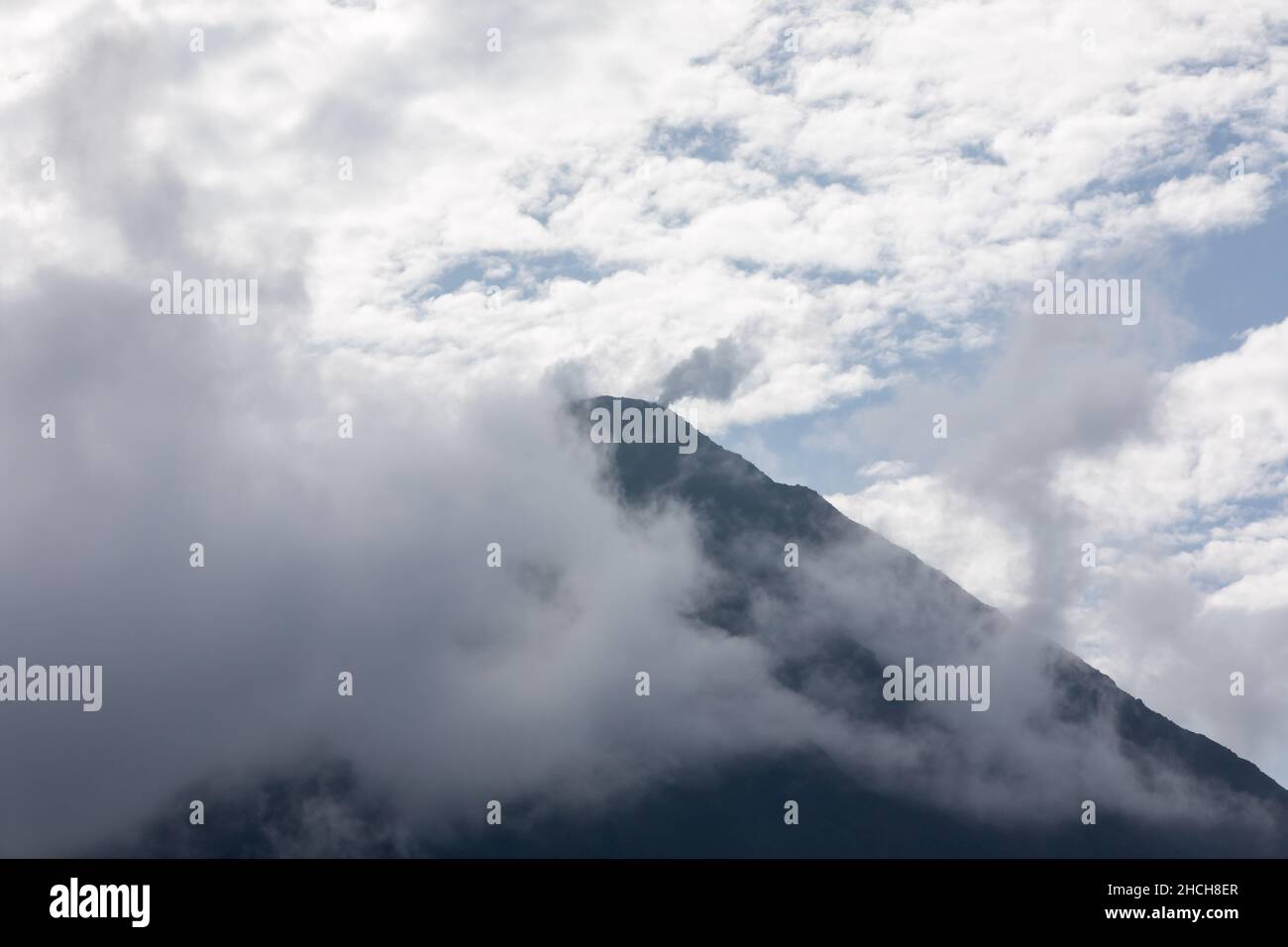 Heavy mist over Arenal Volcano, active andesitic stratovolcano in north ...
