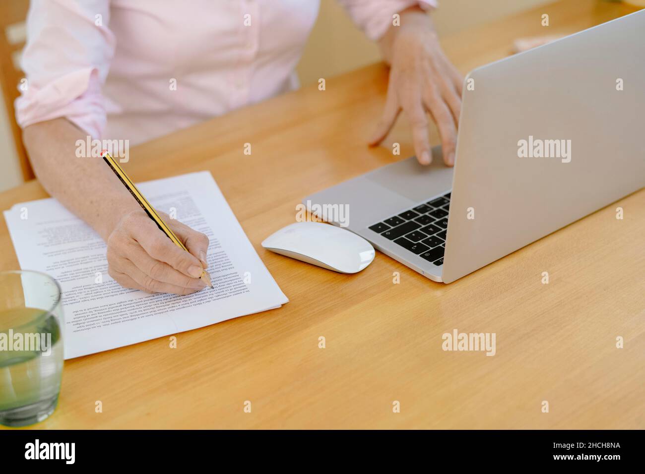 Woman proofreading at her desk Stock Photo - Alamy