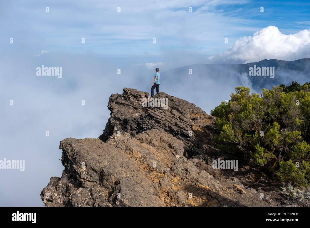 Woman looking up at El Golfo, west coast, hiking trail to the highest ...