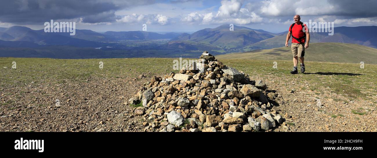 Walker at the summit of Great Dodd fell above St Johns in the Vale ...