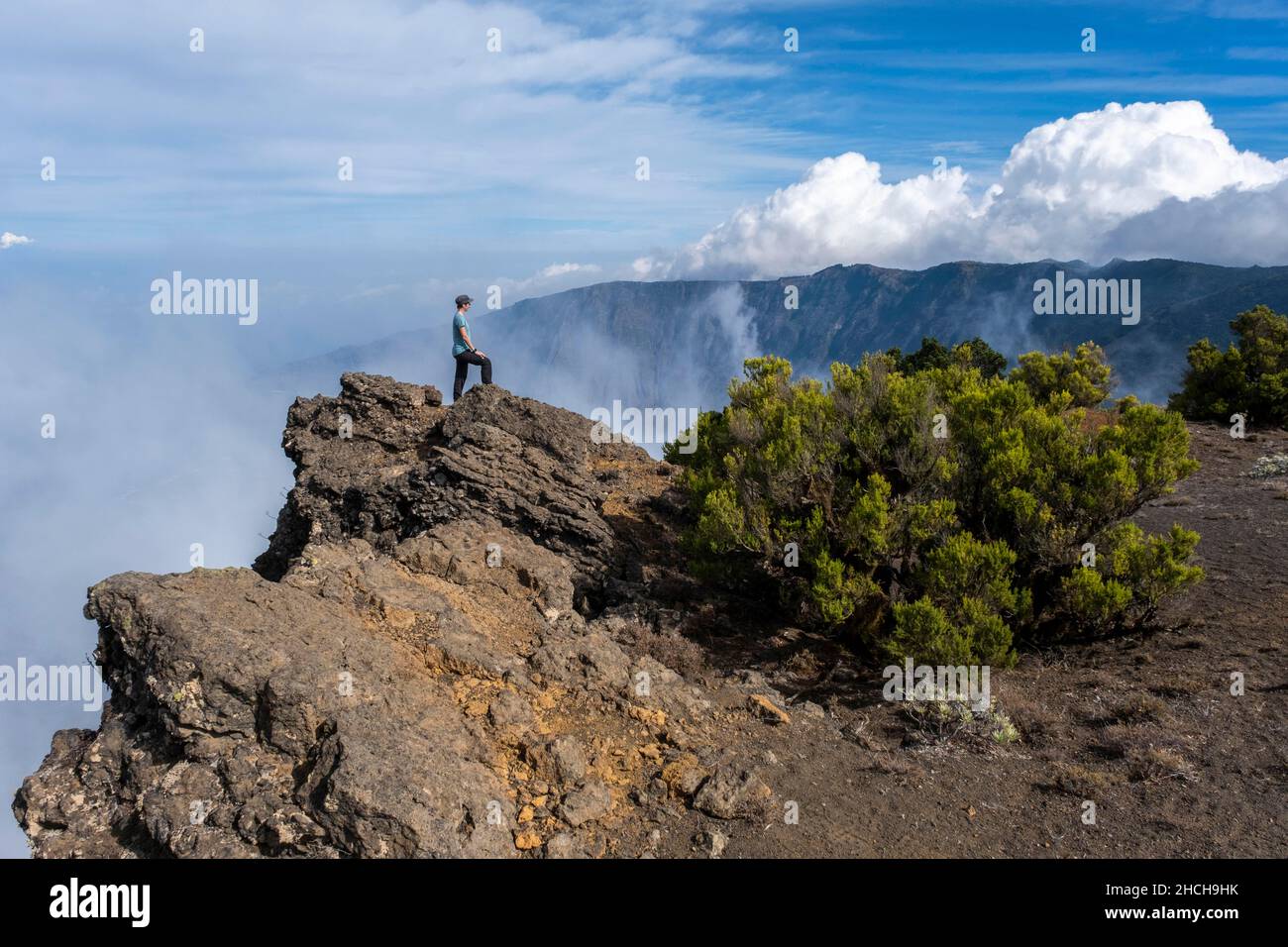 Woman looking up at El Golfo, west coast, hiking trail to the highest ...