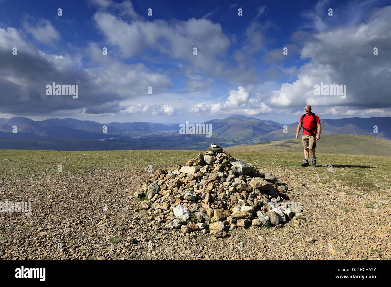 Walker at the summit of Great Dodd fell above St Johns in the Vale ...