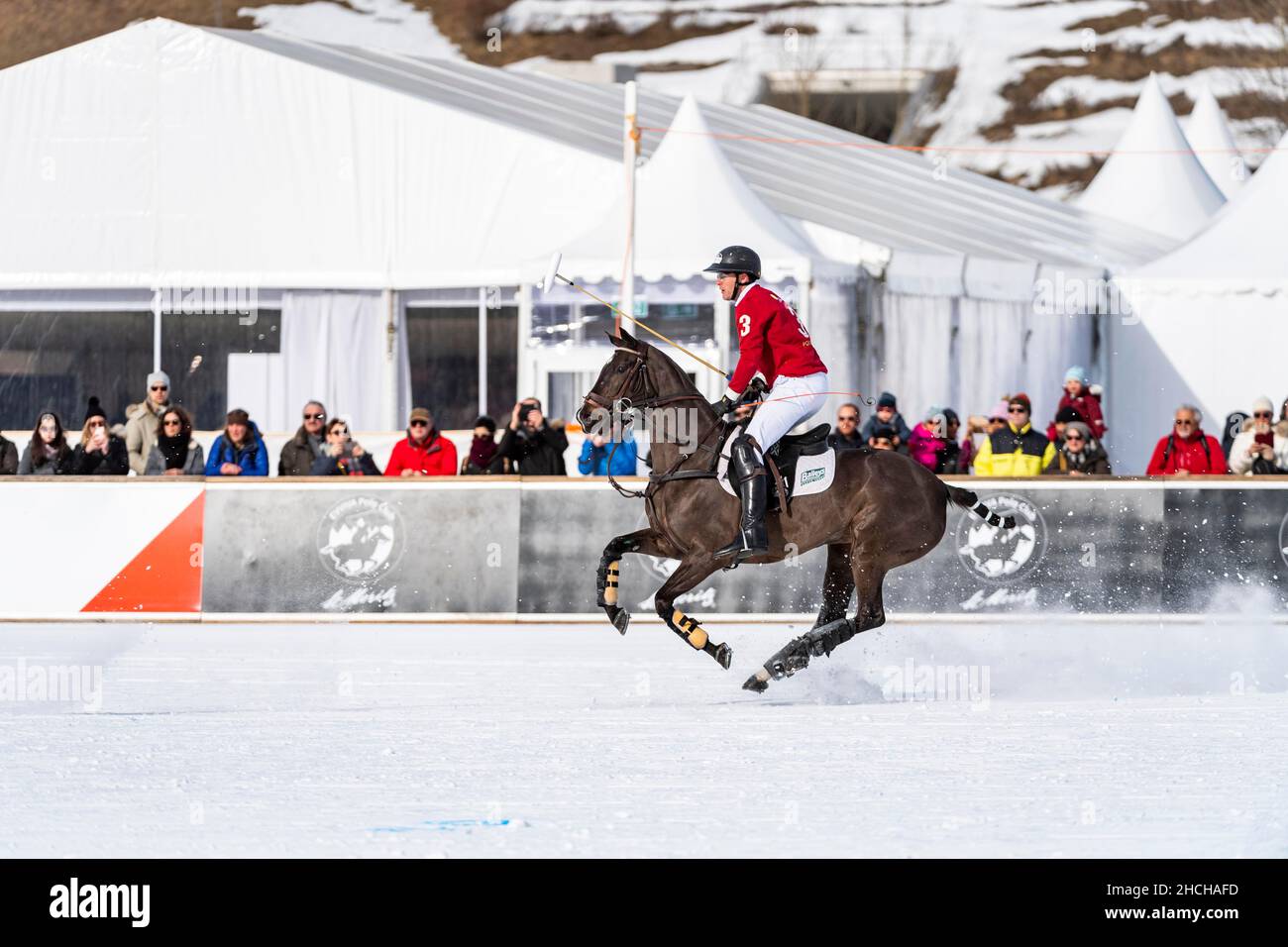 Max Charlton of Team St. Moritz gallops along the rail with his horse ...