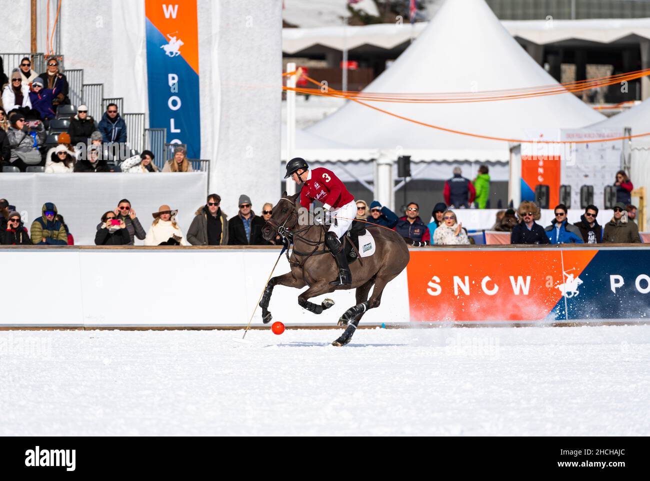 Spectators watch Max Charlton of Team St. Moritz galloping across the ...