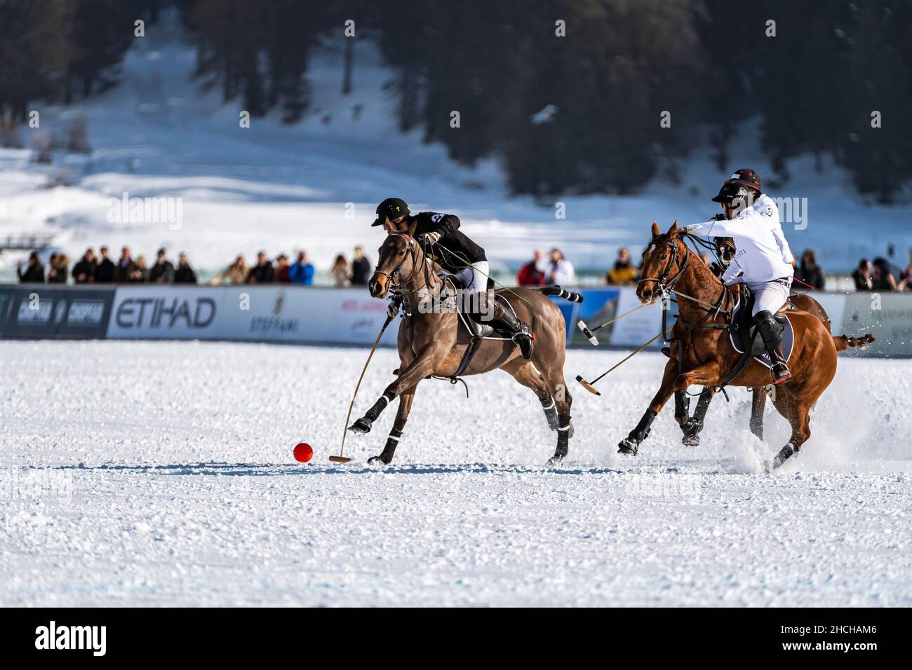 Nic Roldan (black) of Team Badrutt's Palace Hotel with ball is chased ...