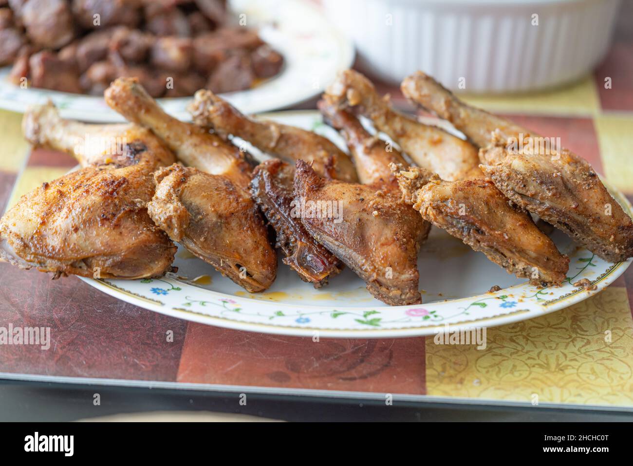 Grilled chicken thighs ready to eat on a buffet Stock Photo - Alamy