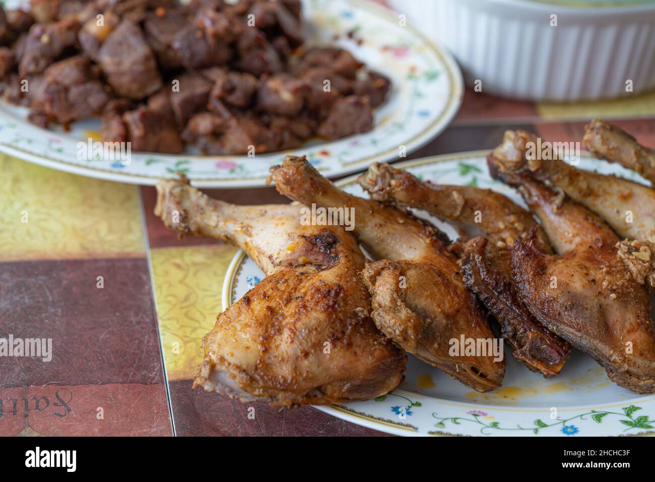 Grilled chicken thighs ready to eat on a buffet Stock Photo - Alamy