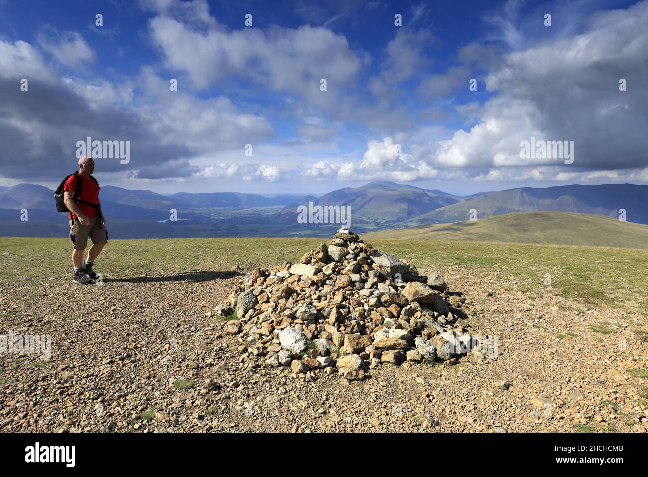 Walker at the summit of Great Dodd fell above St Johns in the Vale ...