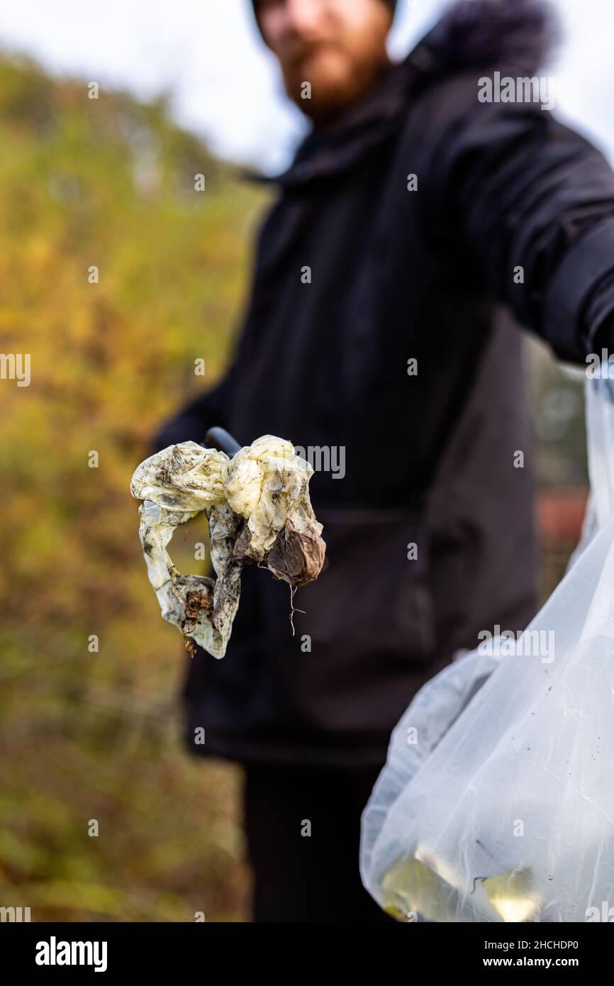 Bawdsey, Suffolk, UK January 06 2021: An adult male doing a beach clean ...
